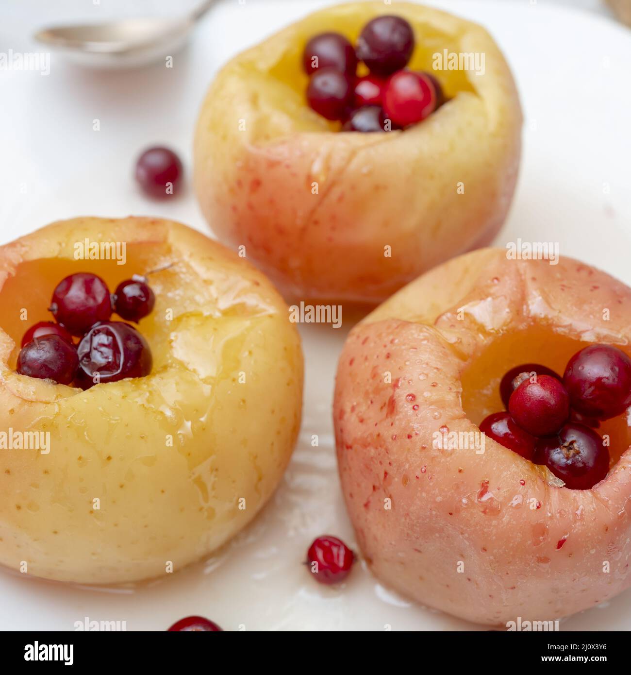 Baked apples with berries Stock Photo - Alamy