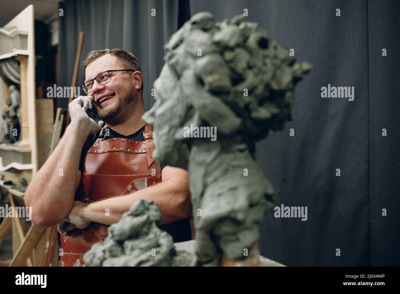 Man sculptor creates sculpt bust clay human woman sculpture. Statue ...