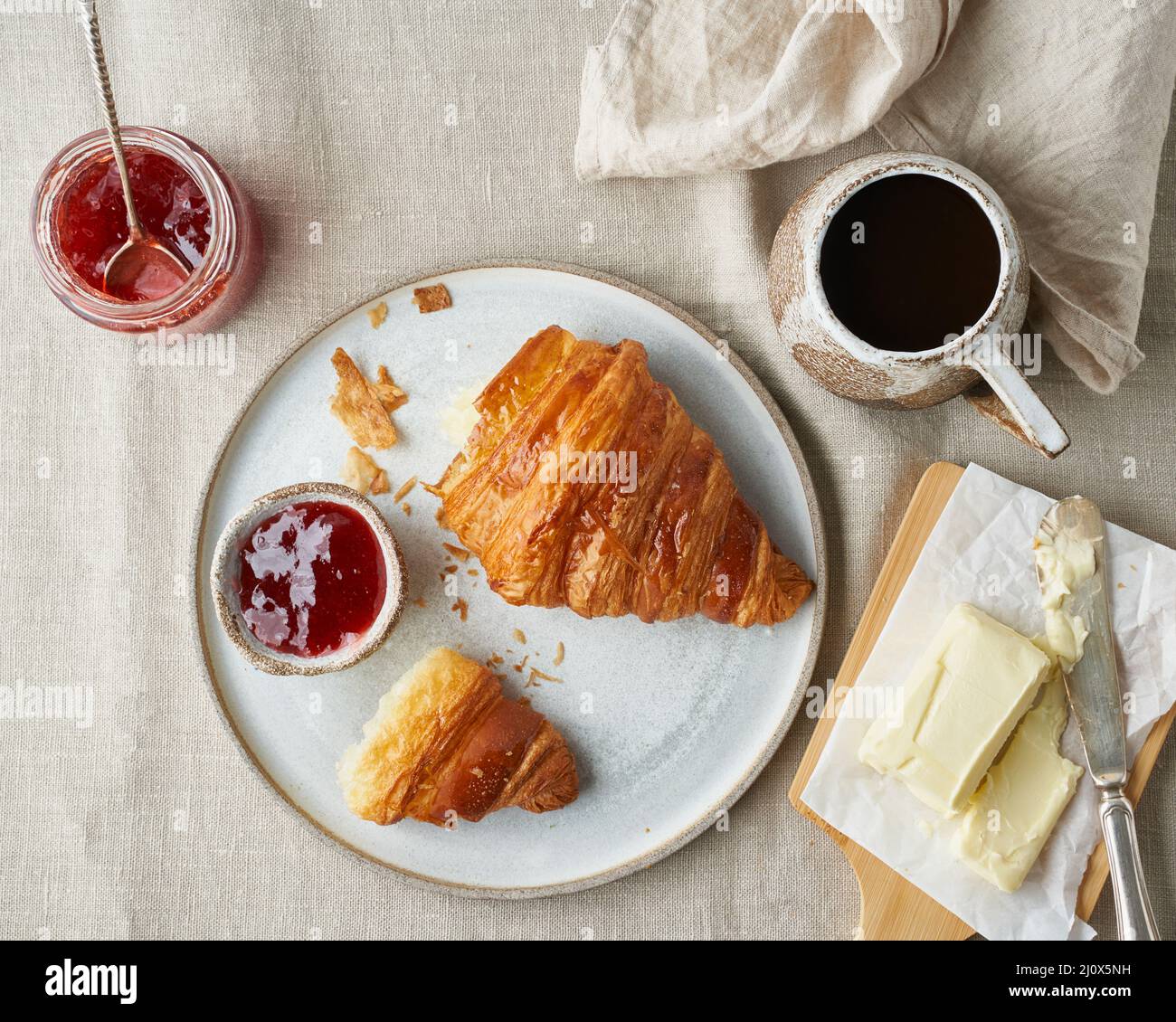 One delicious croissants on plate and hot drink in mug. Morning French ...