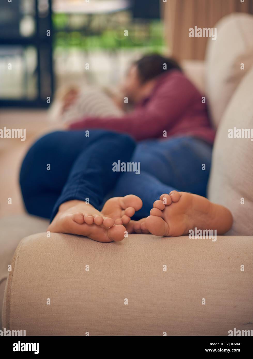 Better together. A young couple napping together on the sofa Stock ...