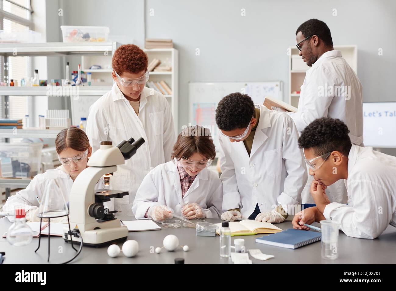 Front view at diverse group of smiling children enjoying experiments ...