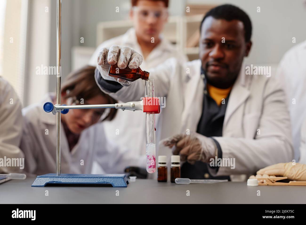 Close up of African American teacher demonstrating science experiments ...