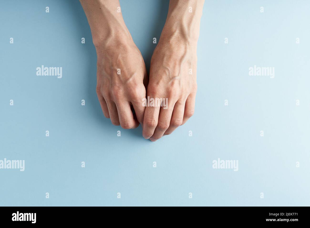 Hard-working hands with protruding veins on blue background Stock Photo ...