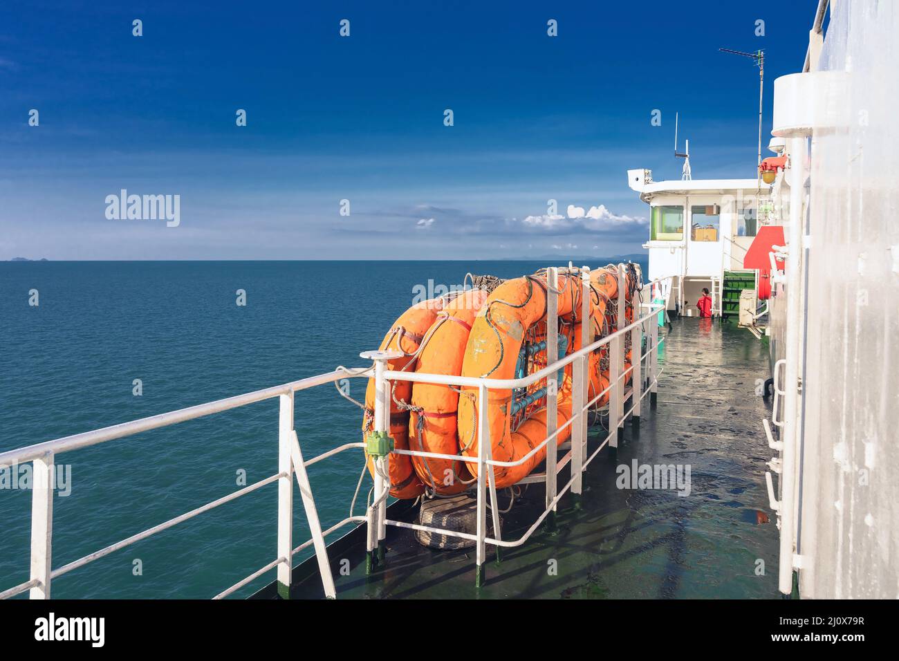 Orange inflatable lifeboats on ferry deck for emergencies and maritime ...