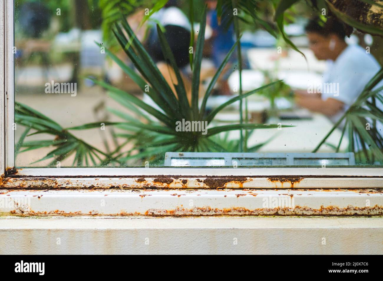 Close up of rust on old white iron window sill with a blurred ...