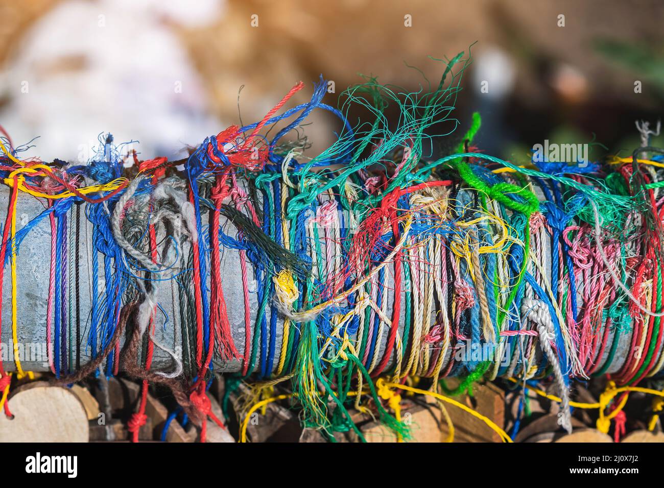 Many suspended chaotically intertwined colorful ropes tied into messy ...