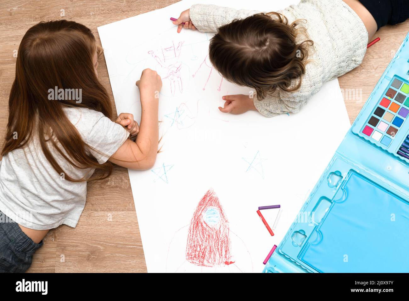 Little boys drawing a picture on the floor in his room, top view ...
