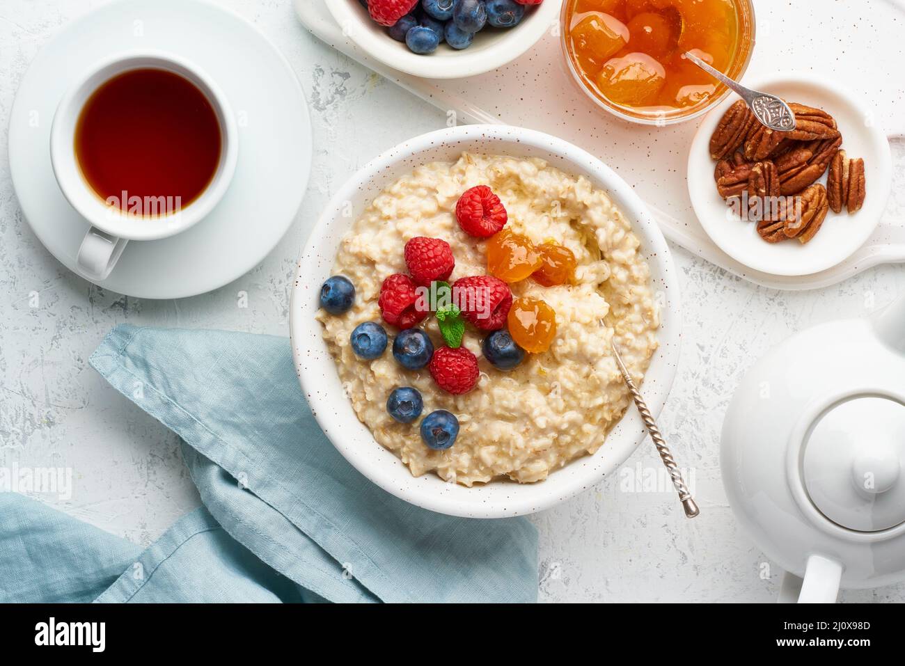 Oatmeal porridge with blueberry, raspberries, jam and nuts, top view ...