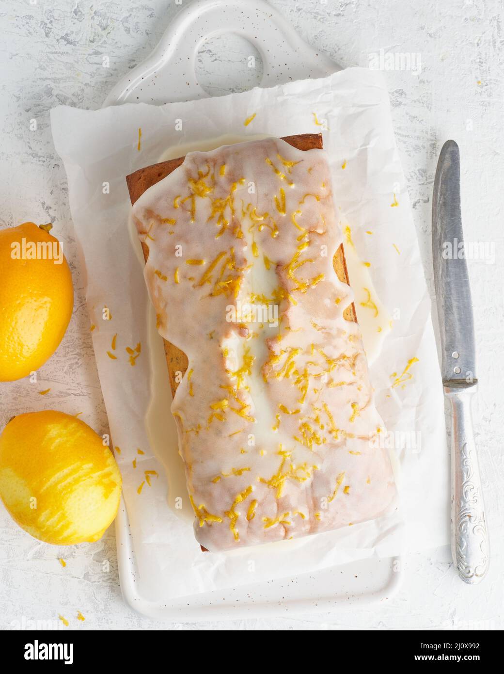 Lemon bread coated with sugar sweet icing. Whole loaf. White background ...