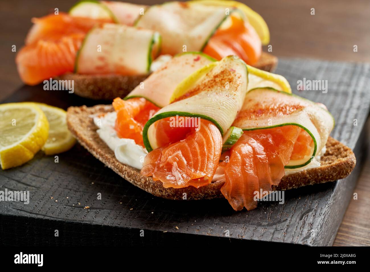Smorrebrod - traditional Danish sandwiches. Black rye bread with salmon ...