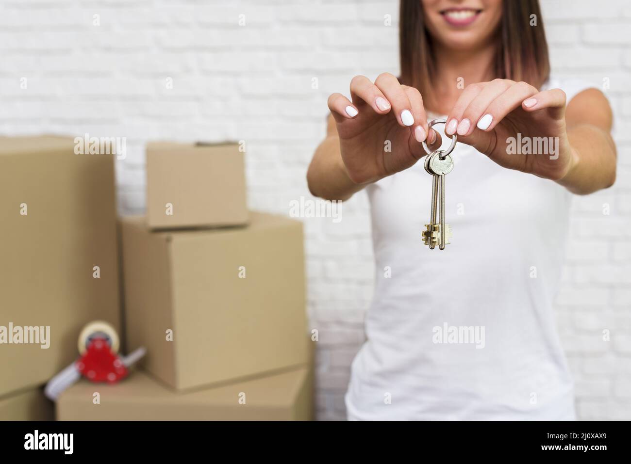 Happy woman holding keys Stock Photo - Alamy