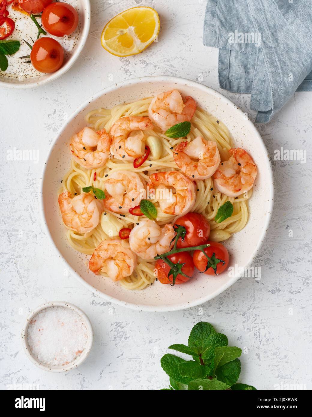 Pasta bavette with fried shrimps, bechamel sauce, mint leaf, garlic, on ...