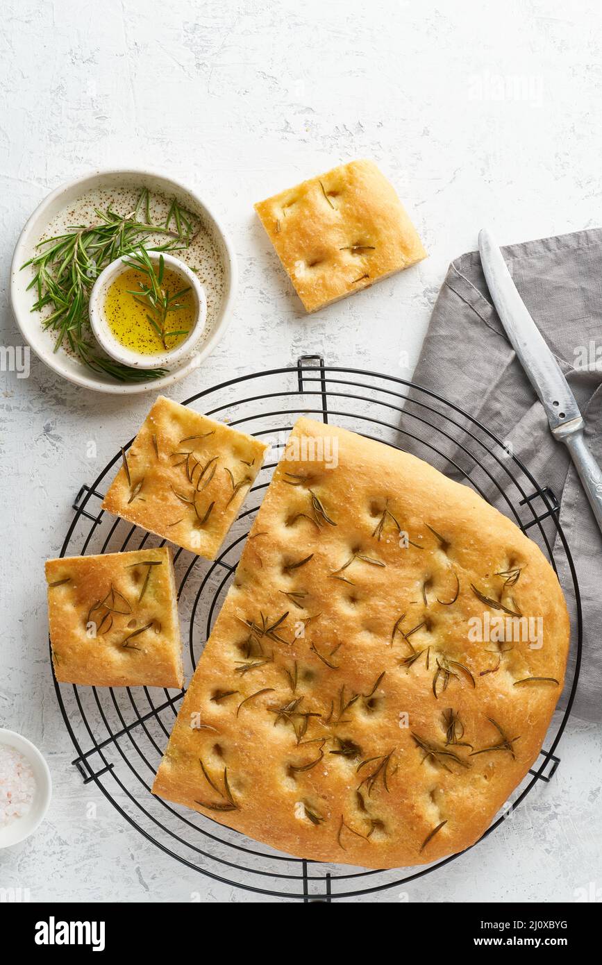 Focaccia, pizza, italian flat bread with rosemary and olive oil on grid ...