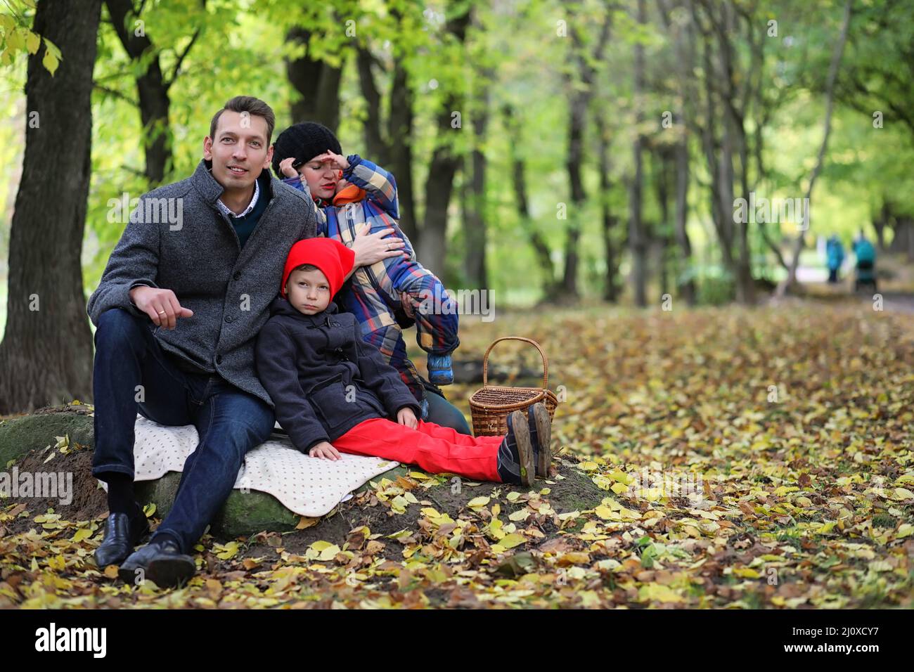 Young family with children on a walk in the park in spring Stock Photo ...