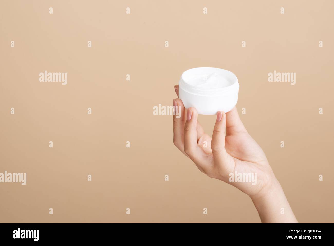 Close up hand holding cream jar. High quality beautiful photo concept ...