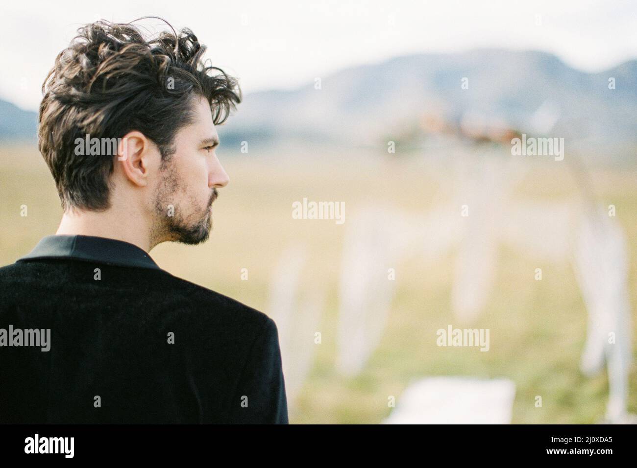 Young man in a black jacket. Back view. Portrait Stock Photo - Alamy