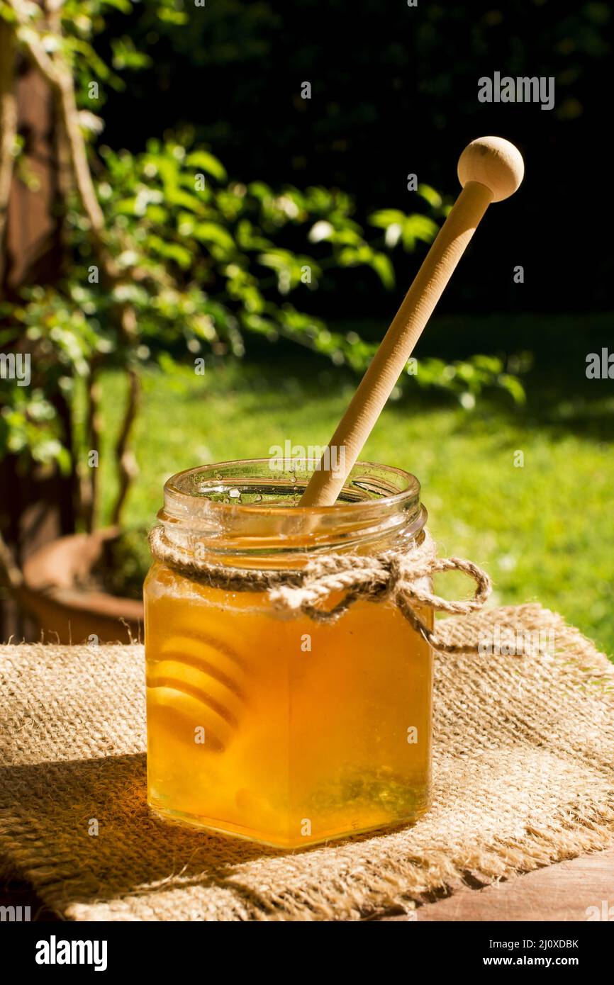 Honey jar with spoon Stock Photo - Alamy