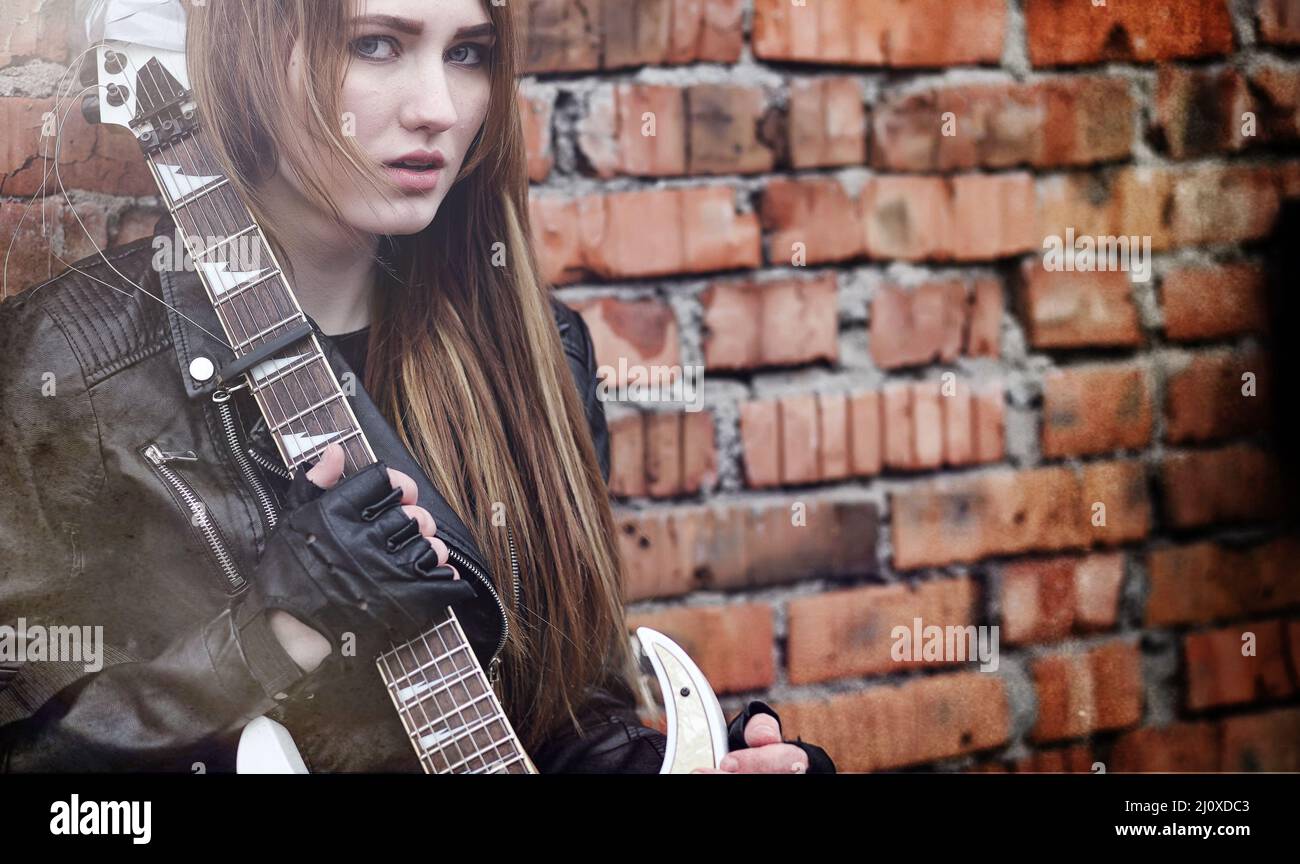 Beautiful young girl rocker with electric guitar. A rock musician girl ...