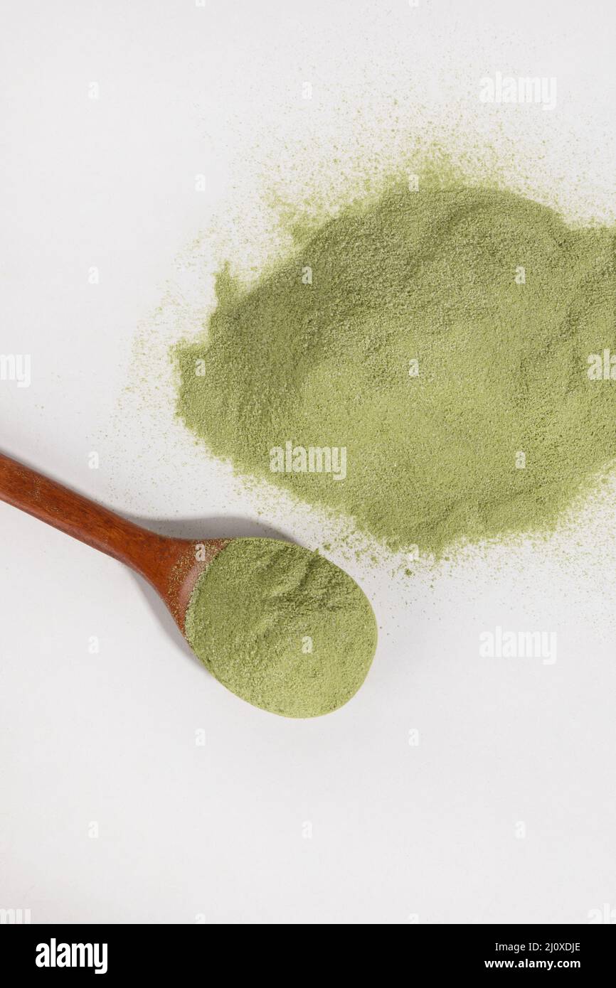 Matcha green tea powder and spoon in white background Stock Photo - Alamy