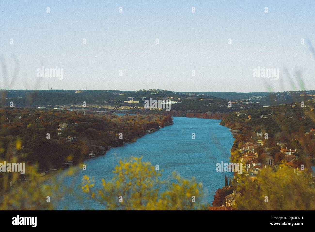 Aerial view of the Colorado River with buildings and dense vegetation ...
