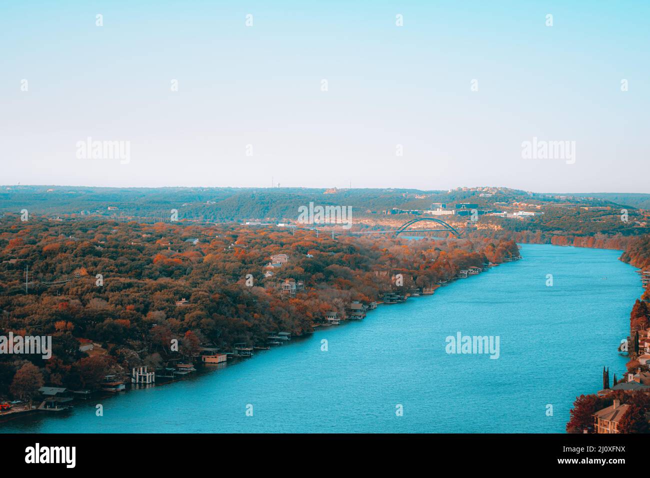 Aerial view of the Colorado River with buildings and dense vegetation ...