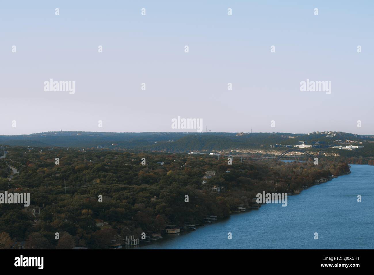 Aerial view of the Colorado River with buildings and dense vegetation ...