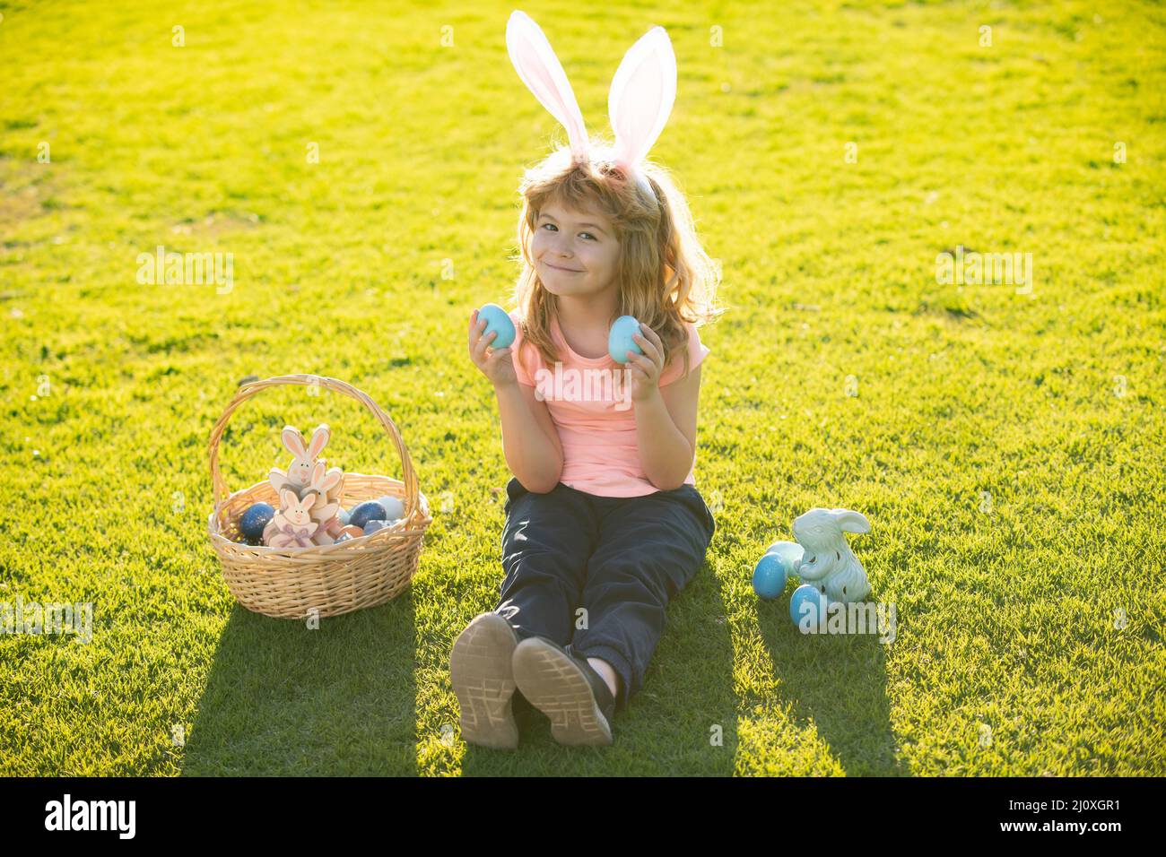 Children celebrating easter. Kid in rabbit costume with bunny ears ...