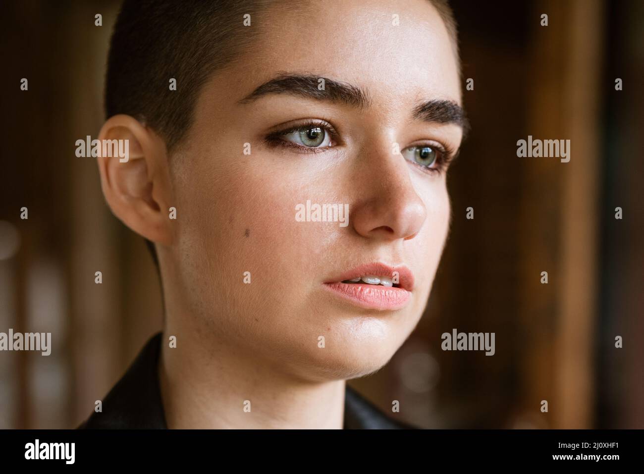 Sad young woman crying, looking away short haircut, closeup portrait in ...
