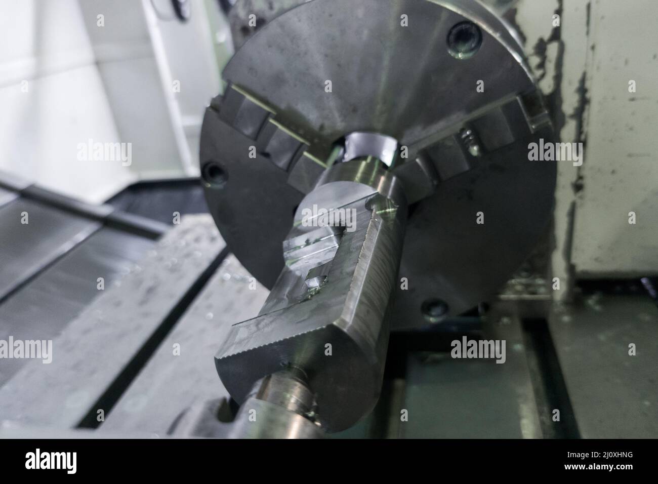 cylindrical workpiece clamped in 4-th axis of cnc milling machine after ...