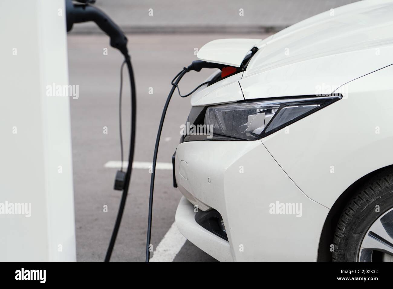 Side view automobile being charged electric vehicle charging station ...
