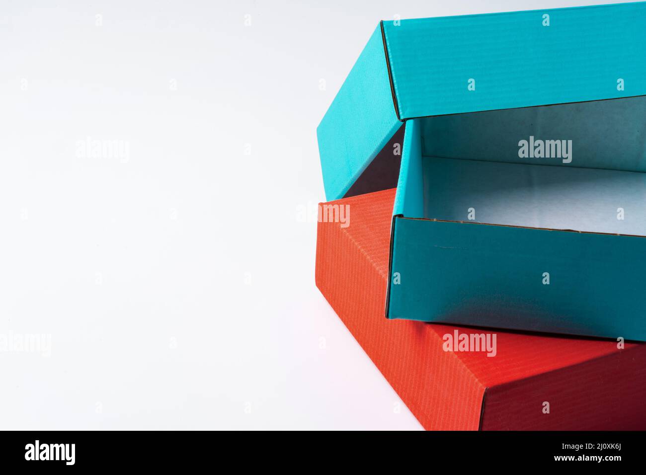 Pile of colorful cardboard boxes on white background Stock Photo - Alamy