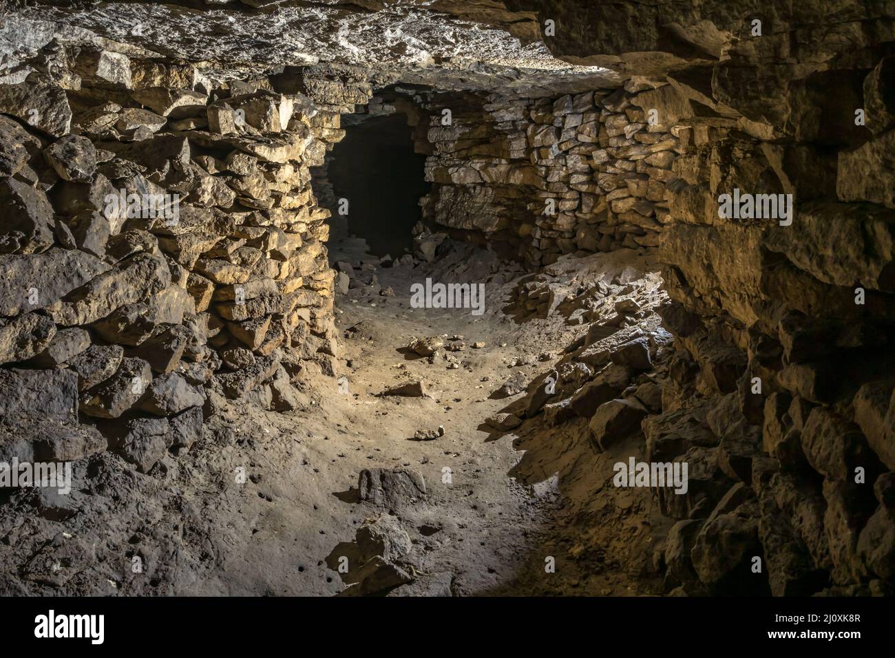 A gallery of old limestone mine illuminated by counter light Stock ...