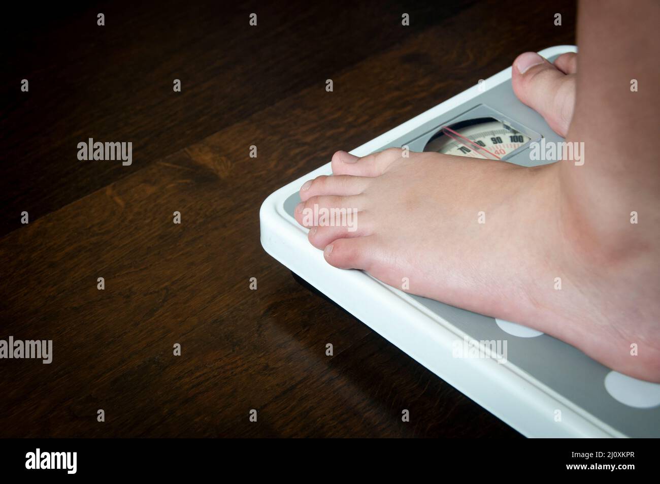 Side top view of feet on weight scale . Weight loss and fitness concept ...