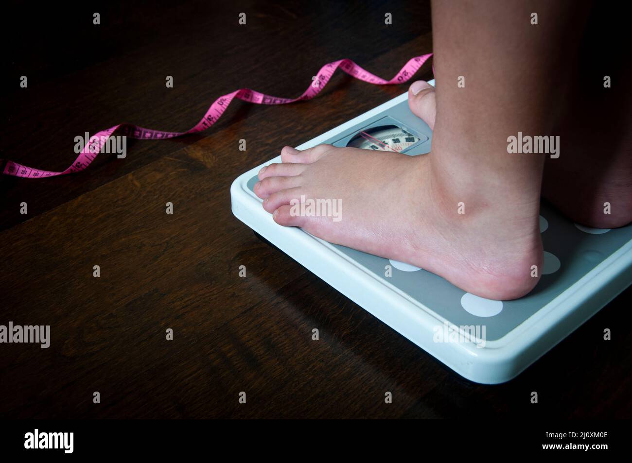 Side view of measuring tape and feet on weight scale . Weight loss and ...