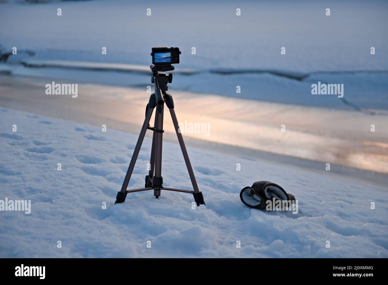 Camera on tripod making time-lapse photography stuck in the snow in ...