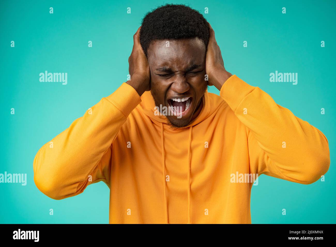 Emotional screaming young african man standing isolated over mint ...