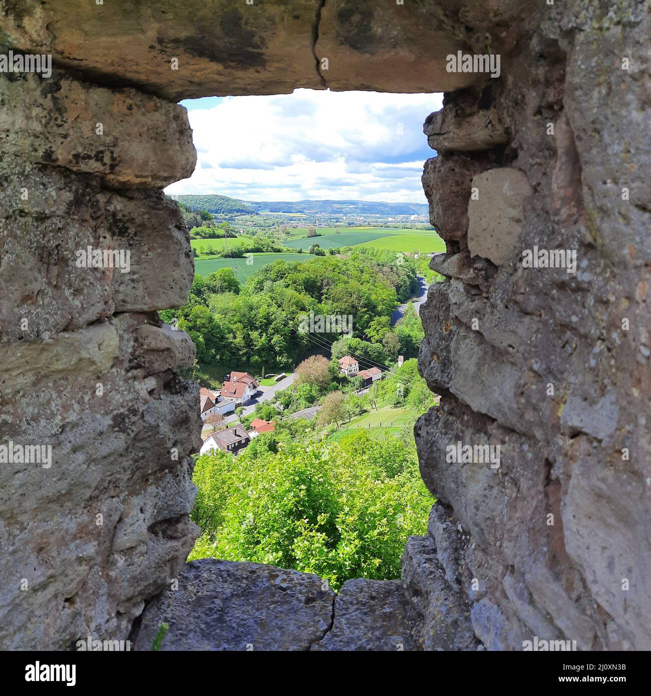 Beautiful view of a small village in a forest from a stone window at ...