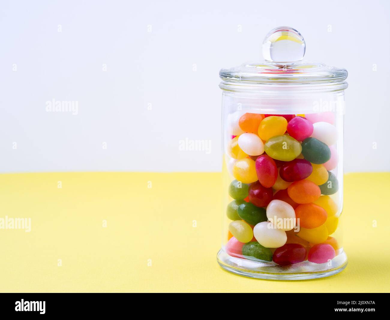 Glass Jar Filled With Candy And Caramel With The Lid Closed On The