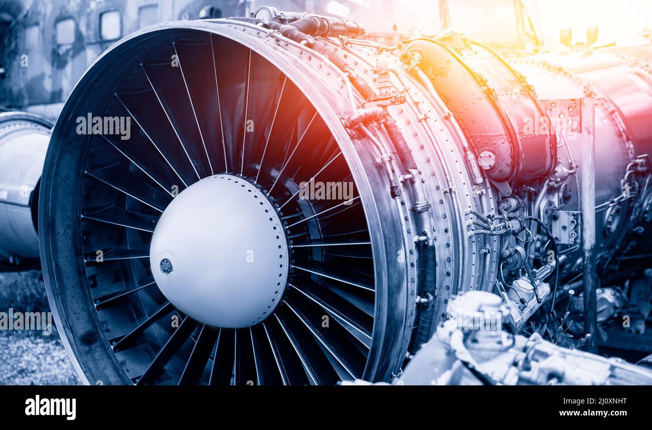 Closeup detail of turbine airplane engine blades. Blue color tone with ...