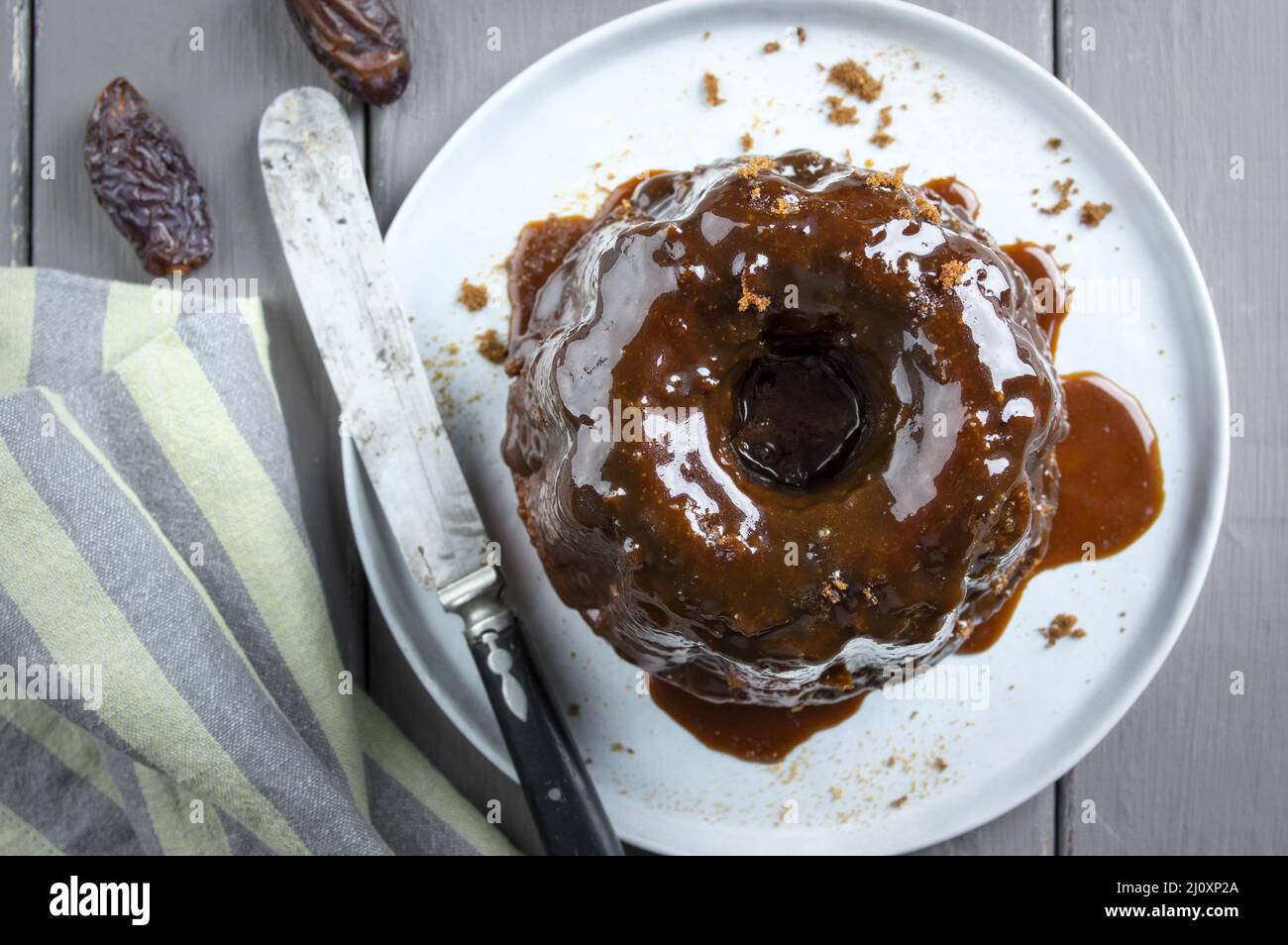Traditional English sticky toffee pudding with caramel glaze served as ...
