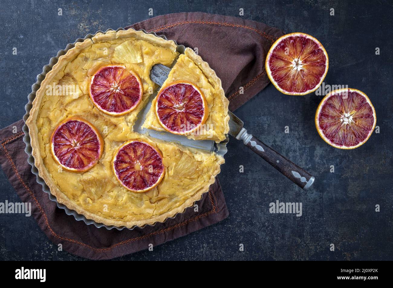 Traditional French tart au citron with blood orange slices served as ...