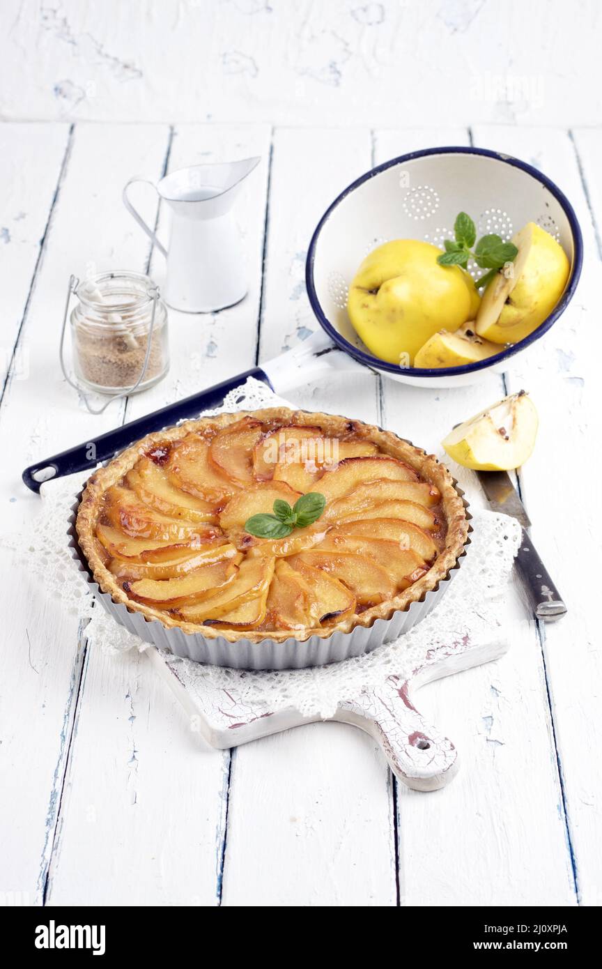 Traditional French quince tart aux pommes served as close-up in classic ...