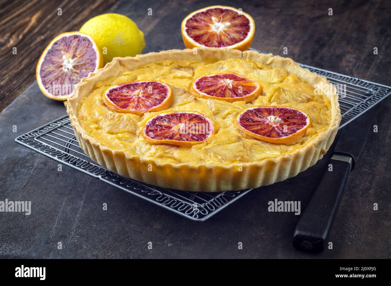Traditional French tart au citron with blood orange slices served as ...