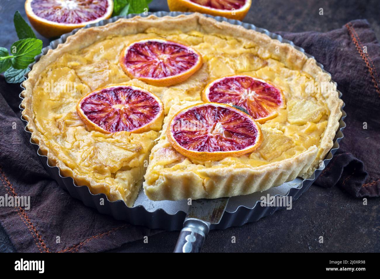 Traditional French tart au citron with blood orange slices served as ...