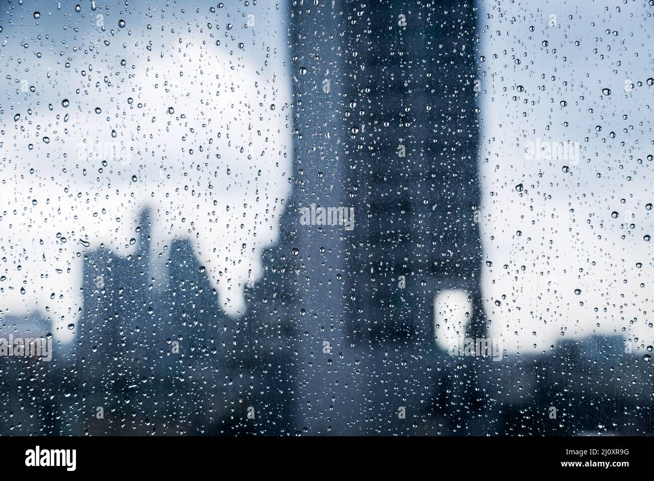 Abstract image of Rain drops on the dirty glass windows with modern ...