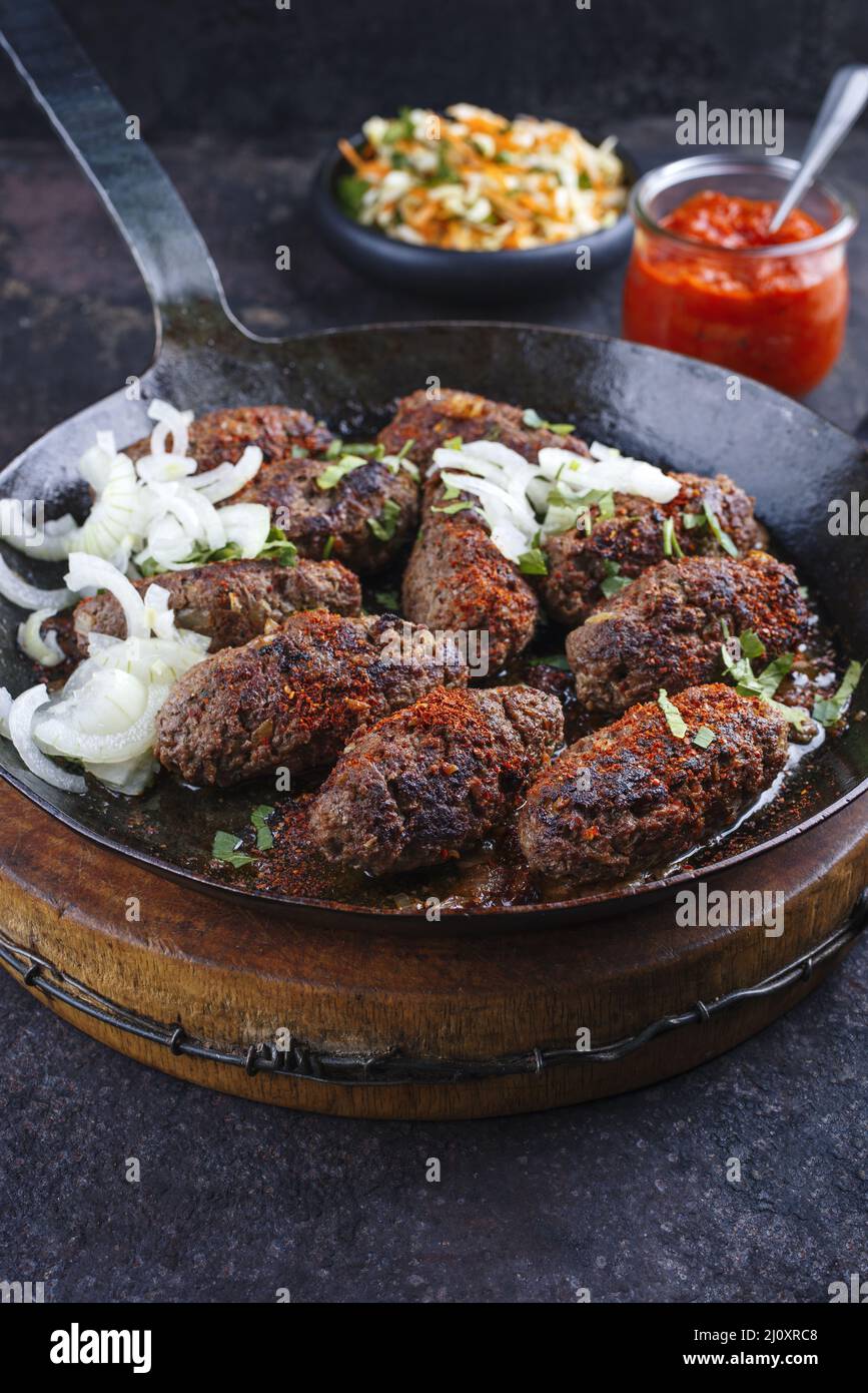 Traditional Croatian cevapcici spicy meat ball rolls with cabbage ...