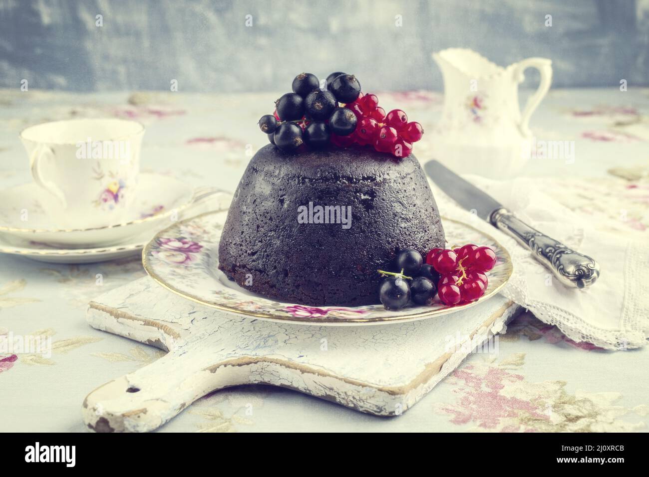 Traditional Australian plum pudding with fresh forest berries offered ...