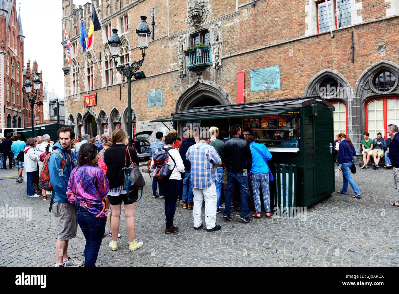 A Belgian Frites and fast food vendor outside the the Belfry of Bruges ...