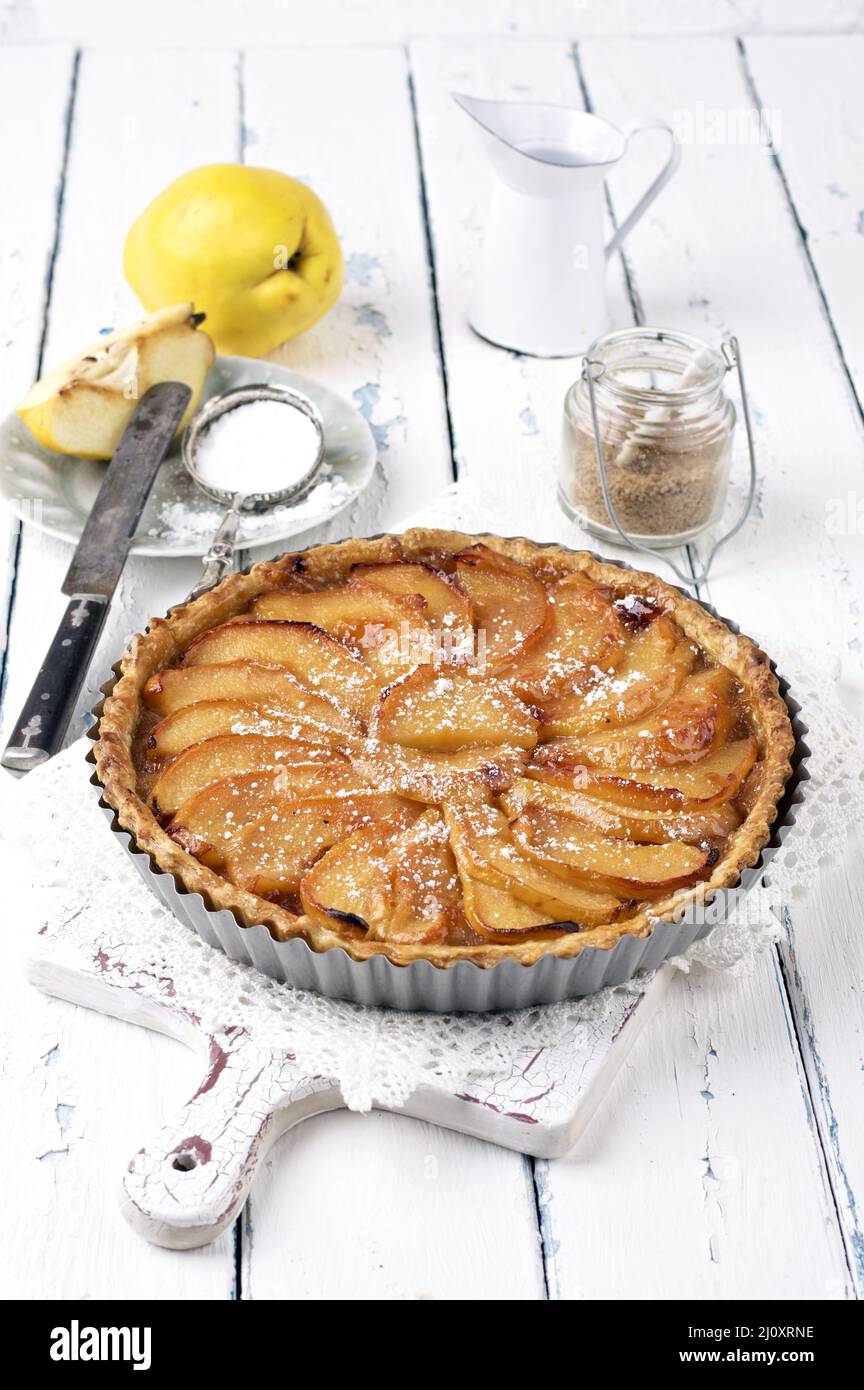 Traditional French quince tart aux pommes served as close-up in classic ...