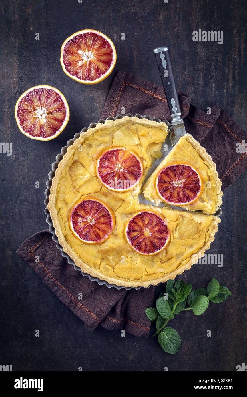 Traditional French tart au citron with blood orange slices served as ...